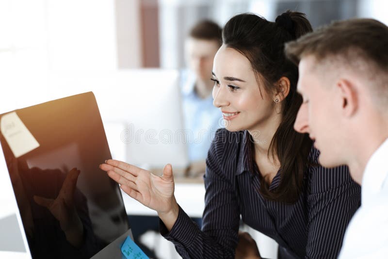 Business Woman and Man Discussing Questions while Using Computer at ...