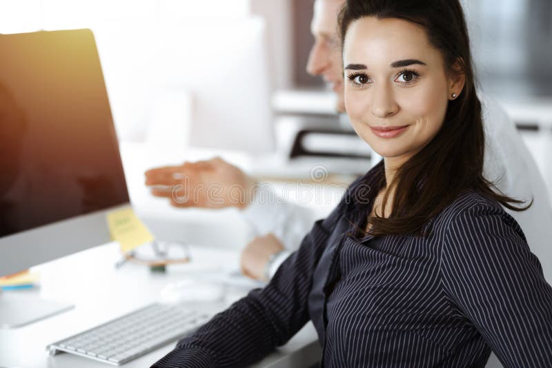 Business Woman and Man Discussing Questions while Using Computer at ...