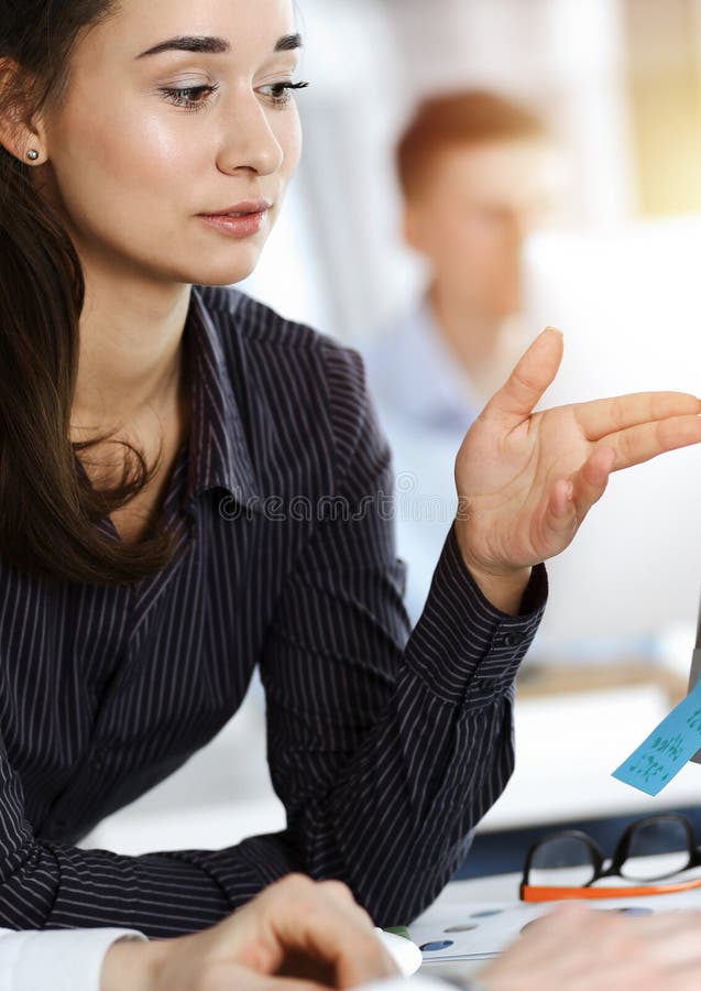 Business Woman and Man Discussing Questions while Using Computer at ...