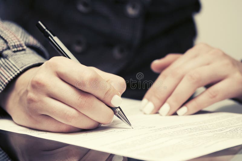 Woman Signing Real Estate Contract Papers with Small Model Home in ...