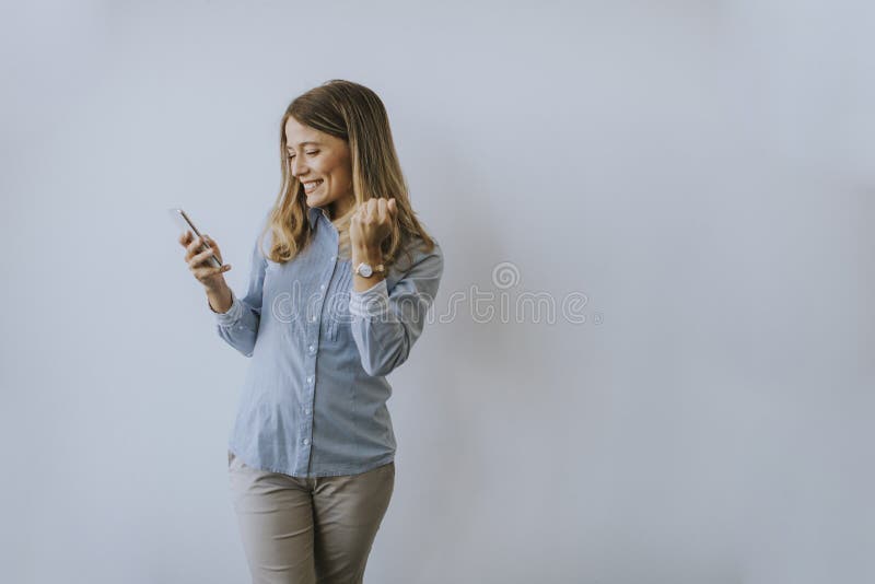 Business Woman Using Mobile Phone by the Wall in the Office Stock Image ...