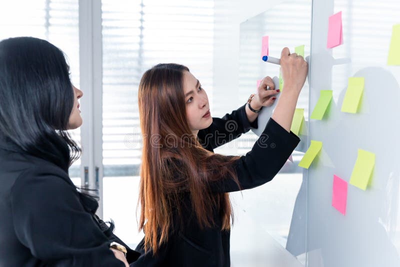 Business Woman Using Post it Note on Glossy White Board Stock Photo ...