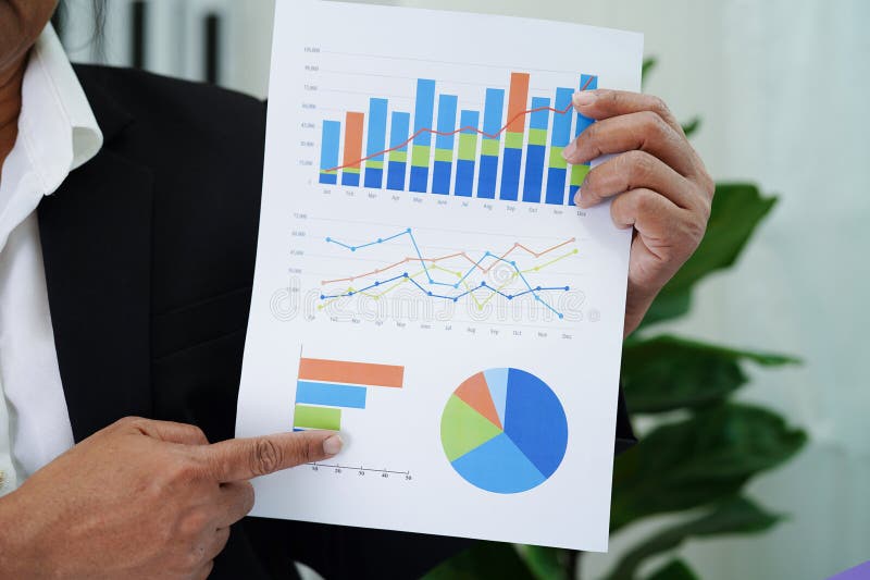 Business Woman Working and Analysis with Statistic Graph in Office ...
