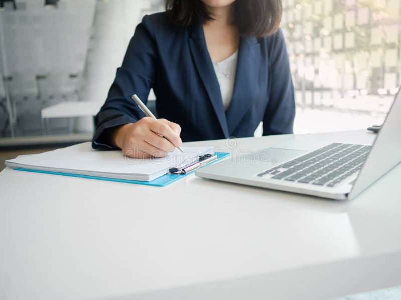 Business Woman Working at a Computer, Writing a Note in Chart. Finance ...