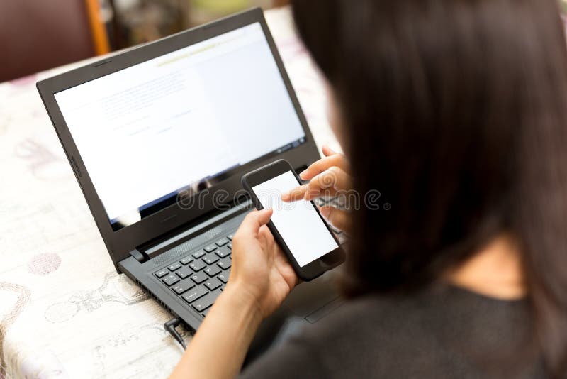 Business Woman Working from Home Using Smart Phone and Lap Top Stock ...