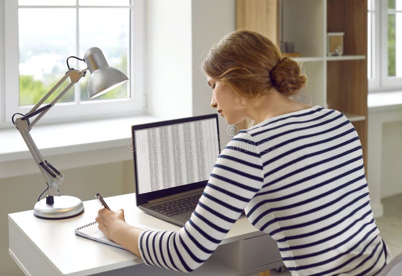 Business Woman Working in Office, Using Spreadsheets and Taking Notes ...