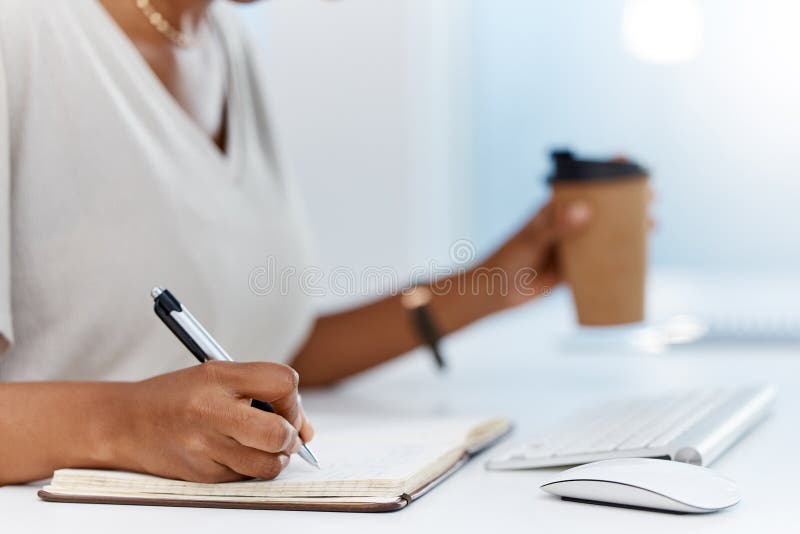 A Business Woman Writing Notes in a Notebook or Managing Her Schedule ...