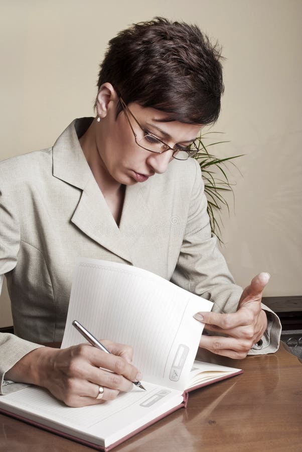Business Woman Writing with Pen in Notepad Stock Photo - Image of focus ...