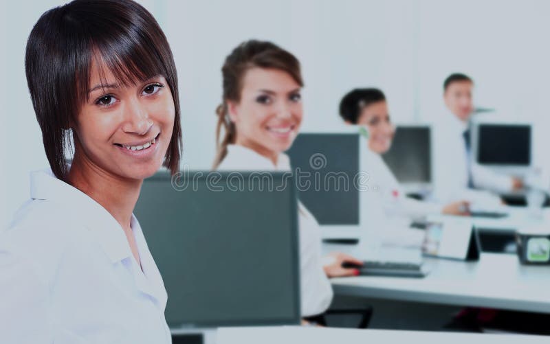 Business Woman with a Computer at the Office with a Group Behind. Stock ...