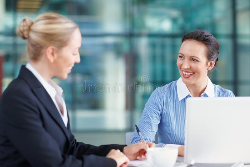Business Women in Discussion. Business Women Discussing while Using ...