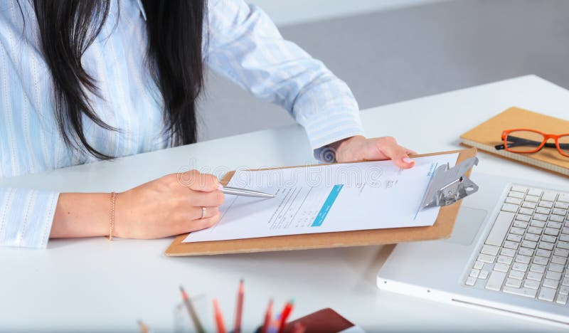 Business Women Sitting on Desk and Writing a Paper Stock Photo - Image ...
