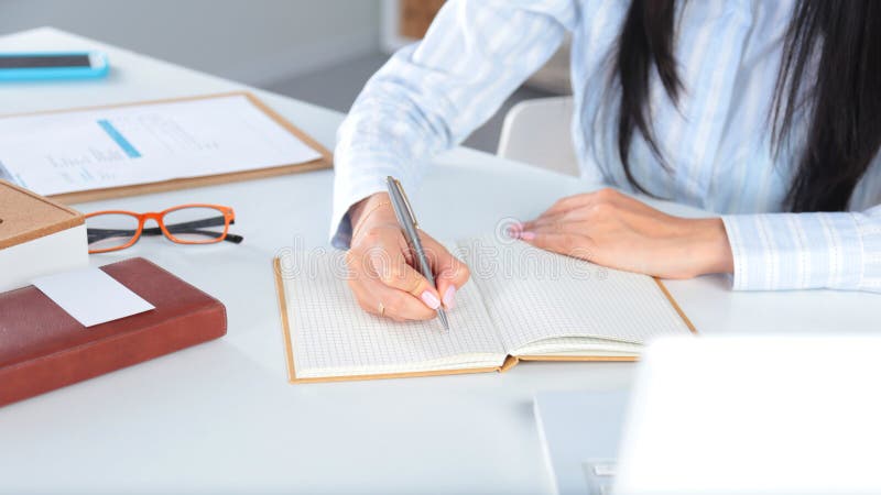 Business Women Sitting on Desk and Writing a Paper Stock Photo - Image ...