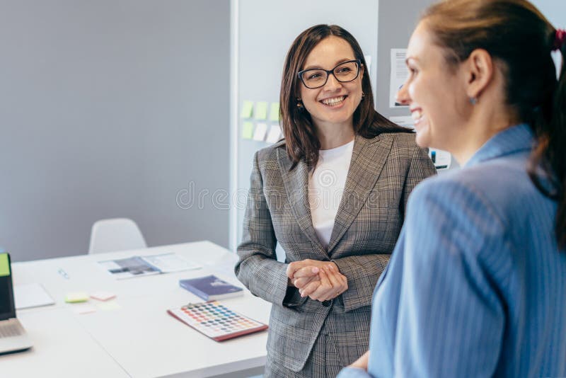 Business Women Standing in the Office and Talking Stock Photo - Image ...