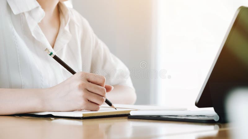 Business Women Using Laptop and Note Some Data on Notepad Stock Image ...