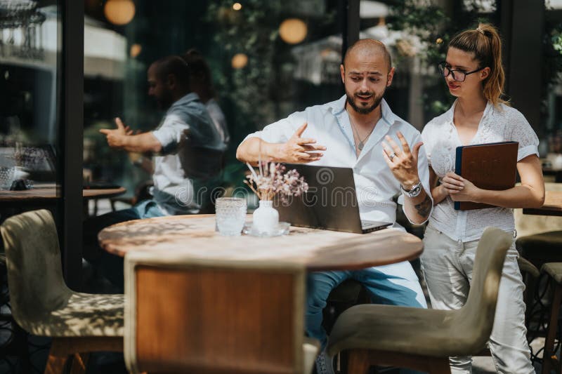 Business Workers Collaborating on a Project in a Coffee Bar ...