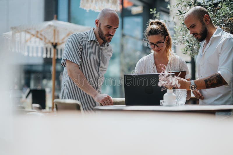 Business Workers Collaborating on a Project in a Coffee Bar ...