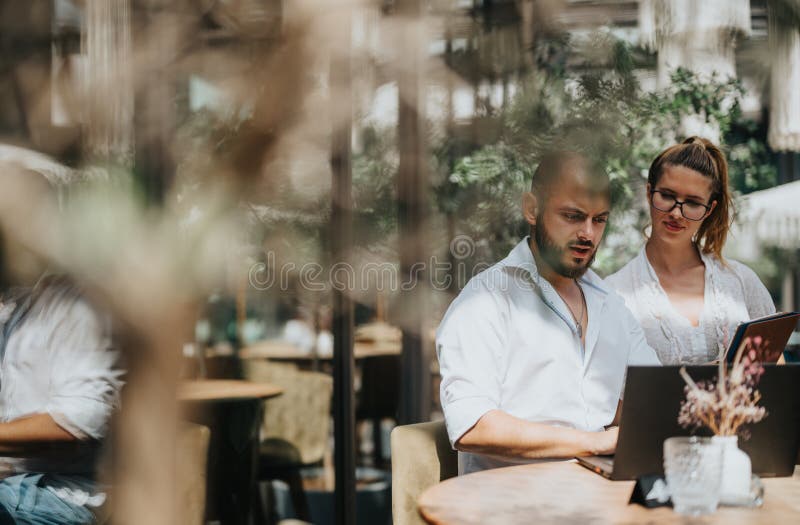 Business Workers Collaborating on a Project in a Coffee Bar ...