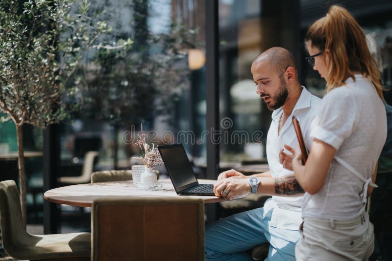 Business Workers Collaborating on a Project in a Coffee Bar ...