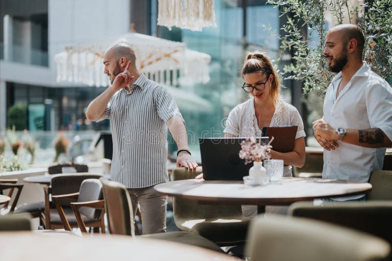 Business Workers Collaborating on a Project in a Coffee Bar ...
