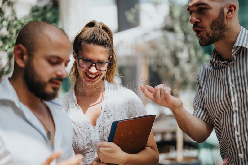 Business Workers Collaborating Together on a Project in a Coffee Bar ...