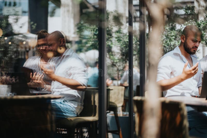Business Workers Collaborating on a Project in a Coffee Bar ...