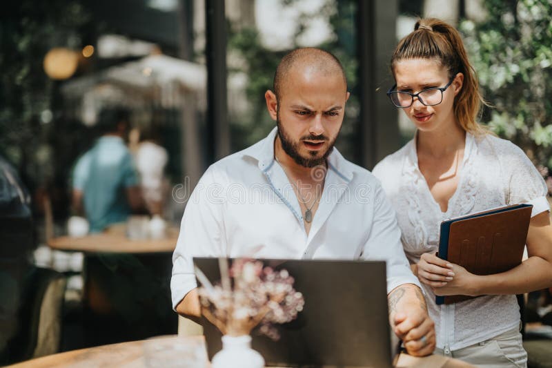 Business Workers Collaborating Together on a Project in a Coffee Bar, Brainstorming Ideas and ...