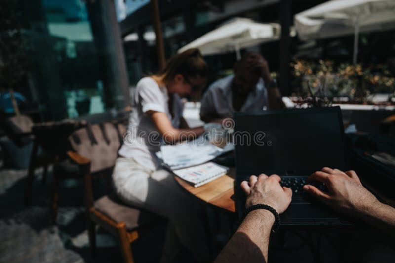 Business Workers Collaborating Together in a Coffee Bar, Sharing Ideas ...