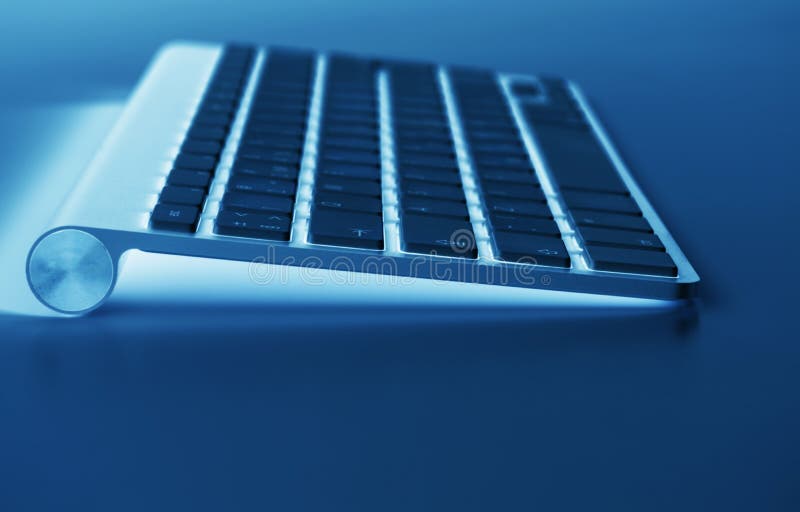 Business Workplace with Computer Wireless Keyboard on Blue Table ...