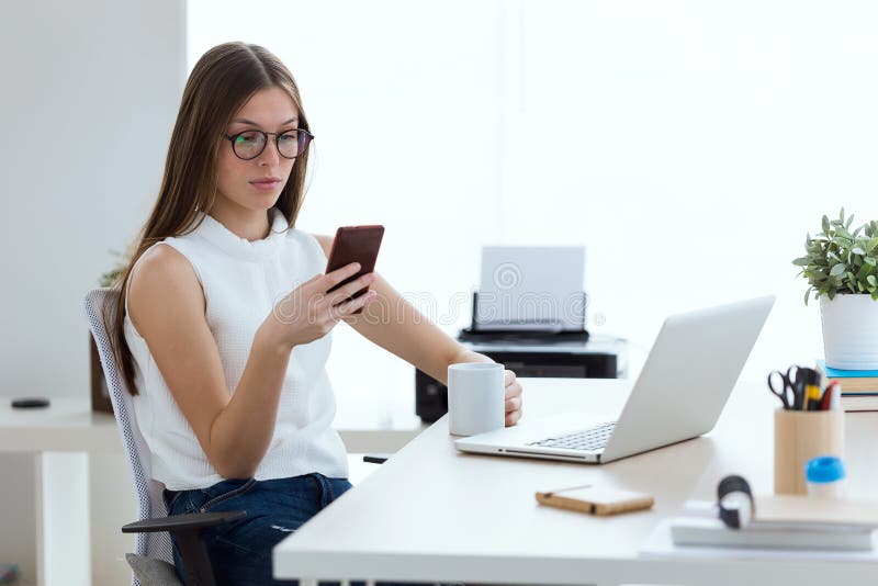 Business Young Woman Using Her Mobile Phone in the Office. Stock Photo ...