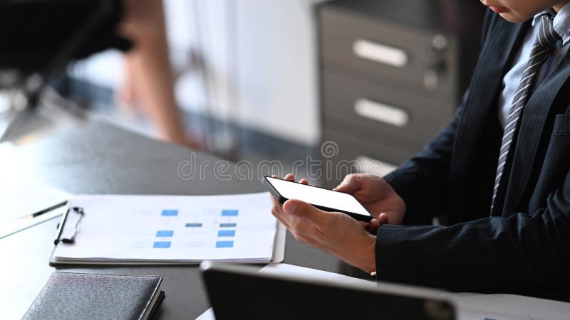 Businessman or Accountant Using Smart Phone with Business Document and ...