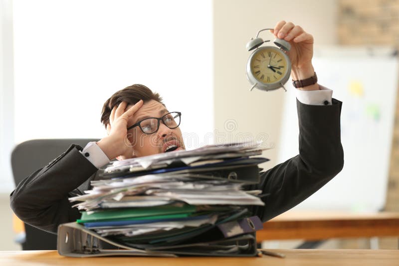 Businessman with Alarm Clock and Stack of Documents in Office. Time ...