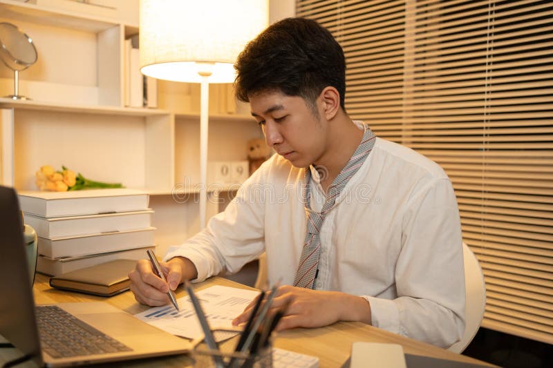 Businessman Analyzes Data Graphs and Works Intently in His Personal ...