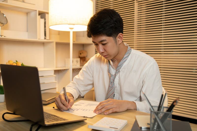 Businessman Analyzes Data Graphs and Works Intently in His Personal ...