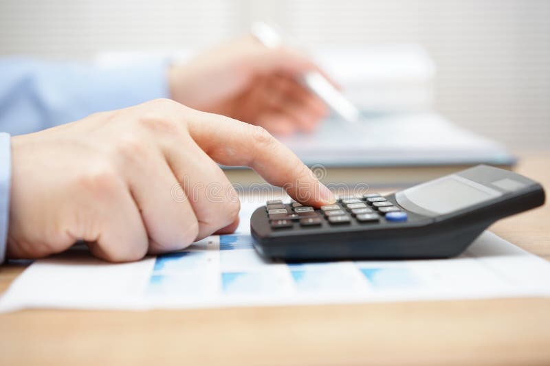 Businessman Analyzing Business Data and Using Calculator Stock Photo ... Businessman Analyzing Business Data and Using Calculator Stock Photo ...