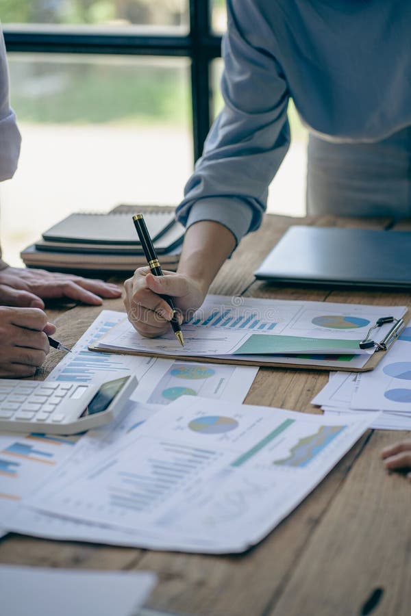 Businessman Analyzing Finances with Documents, Graphs, Accounts and ...