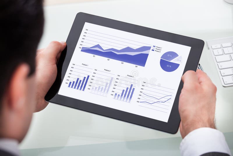 Business Man Working and Analyzing Financial Figures on a Graphs on a ...