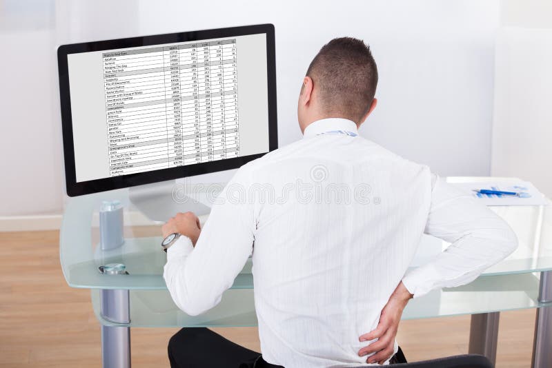Businessman with Backache Using Computer at Desk Stock Photo - Image of ...