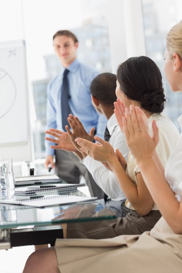Businessman Being Applauded by Colleagues for His Presentation Stock ...