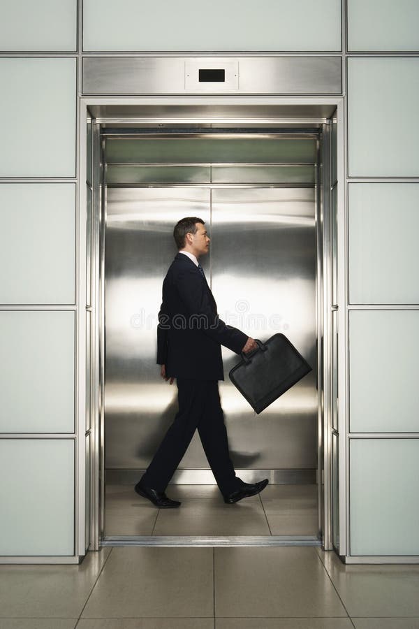 Businessman with Briefcase Walking in Elevator Stock Image - Image of ...