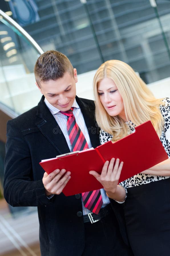 Businessman and Business Woman Talking Over Documents Stock Image ...