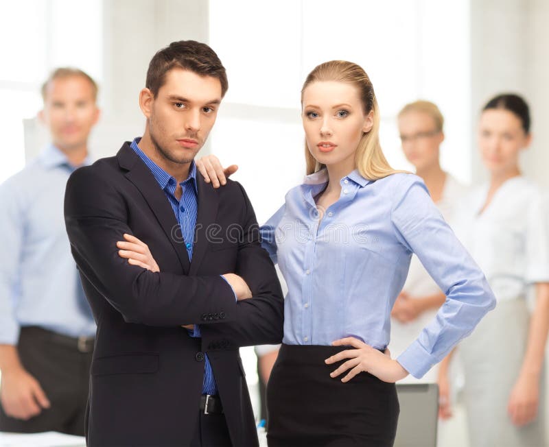 Businessman and Businesswoman in the Front of Team Stock Image - Image ...