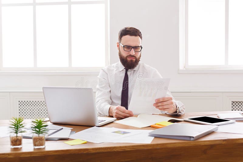 Concentrated Businessman Read Documents in Modern White Office Stock ...