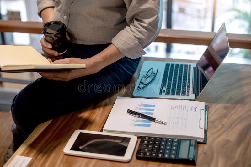 Businessman in Casual Style Working Sitting at the Edge of the Table ...