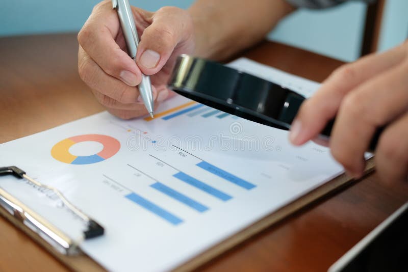 Businessman Checking Chart in Business Document with Magnifying Stock ...