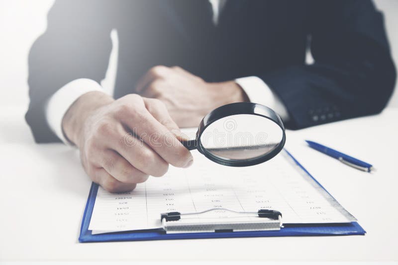 Businessman Checking a Document with a Magnifying Glass Stock Image ...