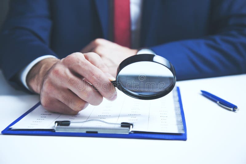 Businessman Checking a Document with a Magnifying Glass Stock Photo ...