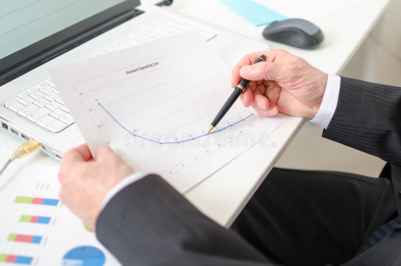 Businessman Checking Financial Charts Stock Photo - Image of hand ...
