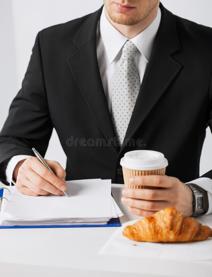 Businessman with Coffee Writing Something Stock Photo - Image of notes ...