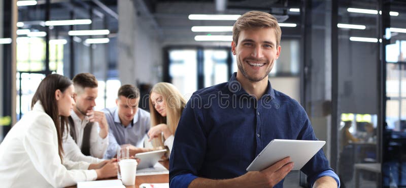 Businessman with Colleagues in the Background in Office. Stock Photo ...