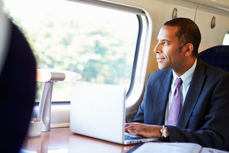 Businessman Commuting To Work on Train Using Mobile Phone Stock Image ...